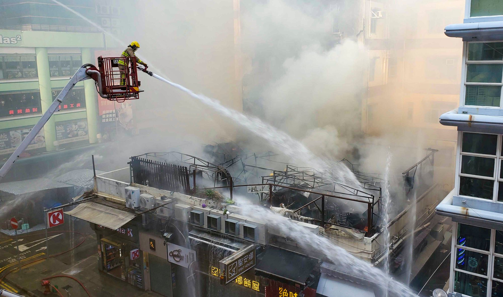 92 people evacuated after fire breaks out at podium of Hong Kong ...