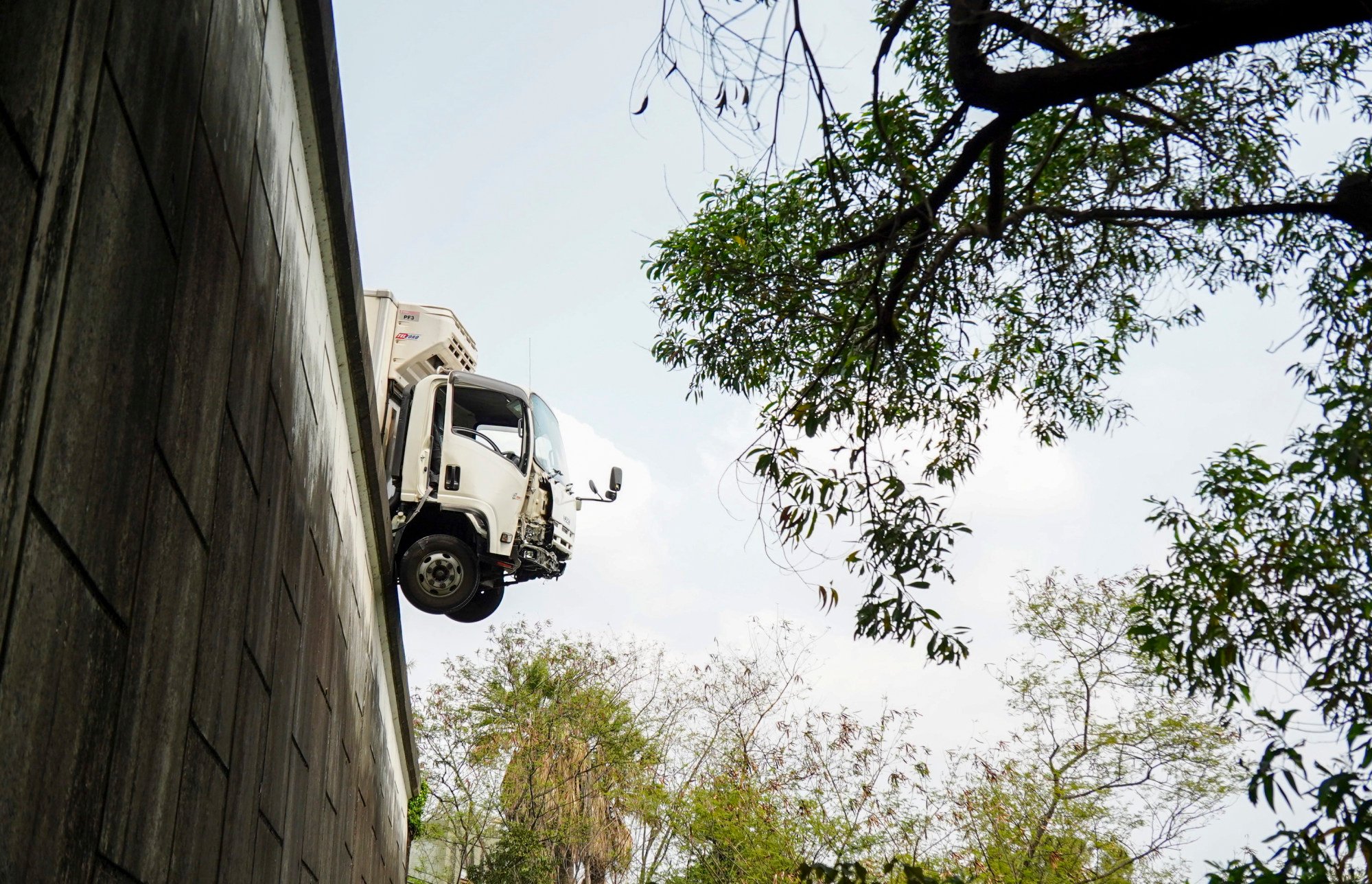 Hong Kong driver and helper lucky to be alive after truck crashes through railings and cabin ...