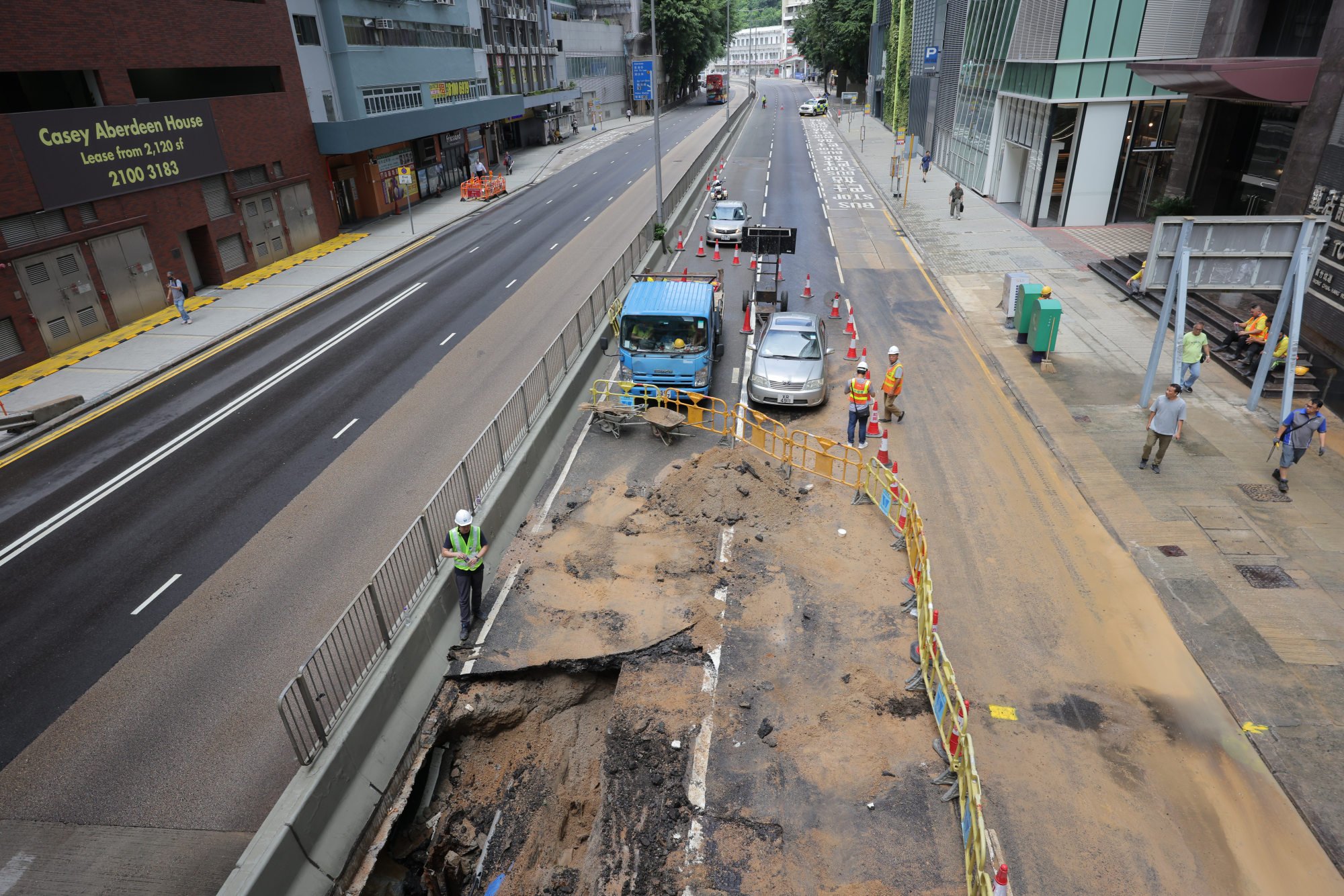 Flooding, road subsidence from burst water pipe disrupt traffic in Hong ...