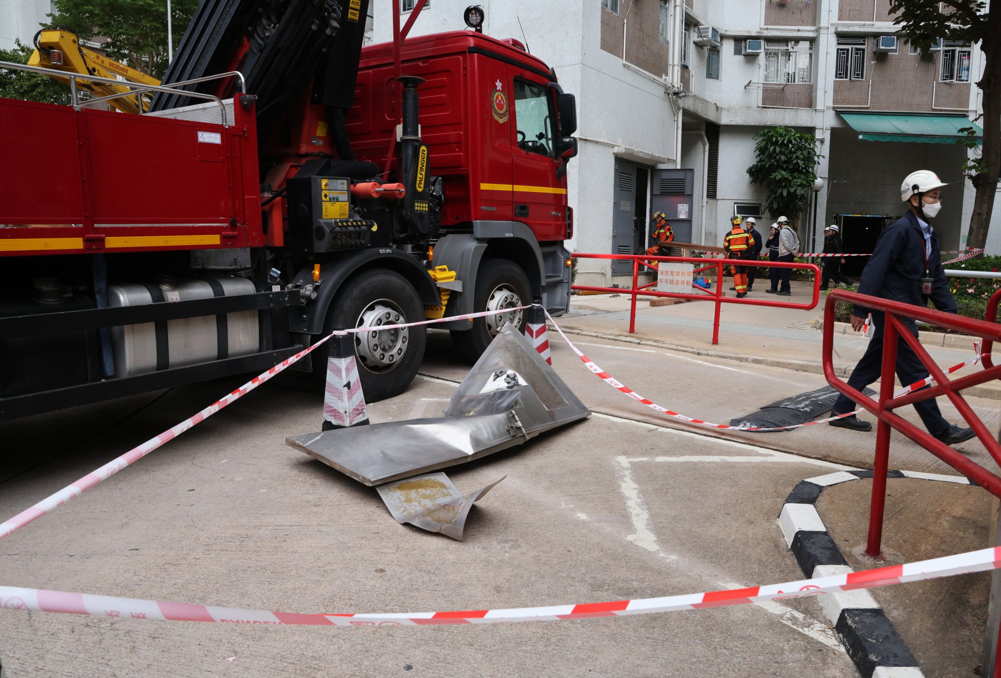 2 Hong Kong workers in narrow escape after blast tears metal door from ...