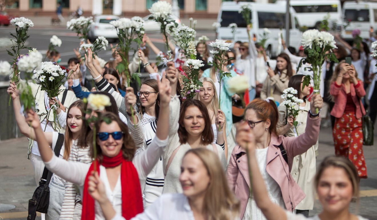 In Belarus, women carrying flowers form human chains in protest at ...