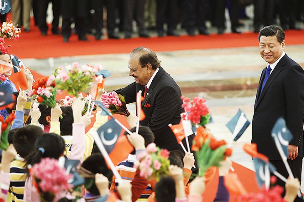 Pakistan's President Hussain and China's President Xi greet children holding flowers and miniature flags of both countries during a welcoming ceremony in Beijing. Photo: Reuters
