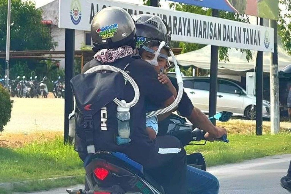 Malaysian couple who went viral for riding motorbike with sick baby on ...