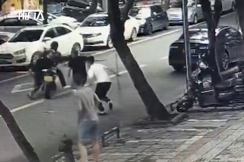 Chinese police officer dragged along ground for 20 metres by motorbike ...