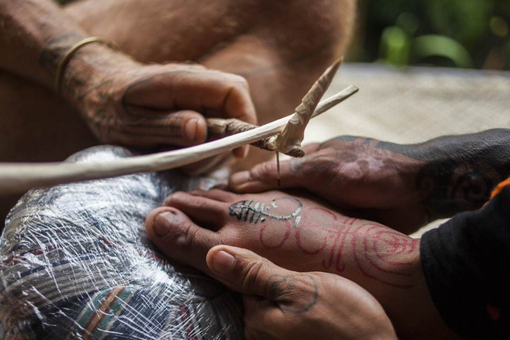 Indonesian tattooists revive tribal traditions by tapping into the past ...