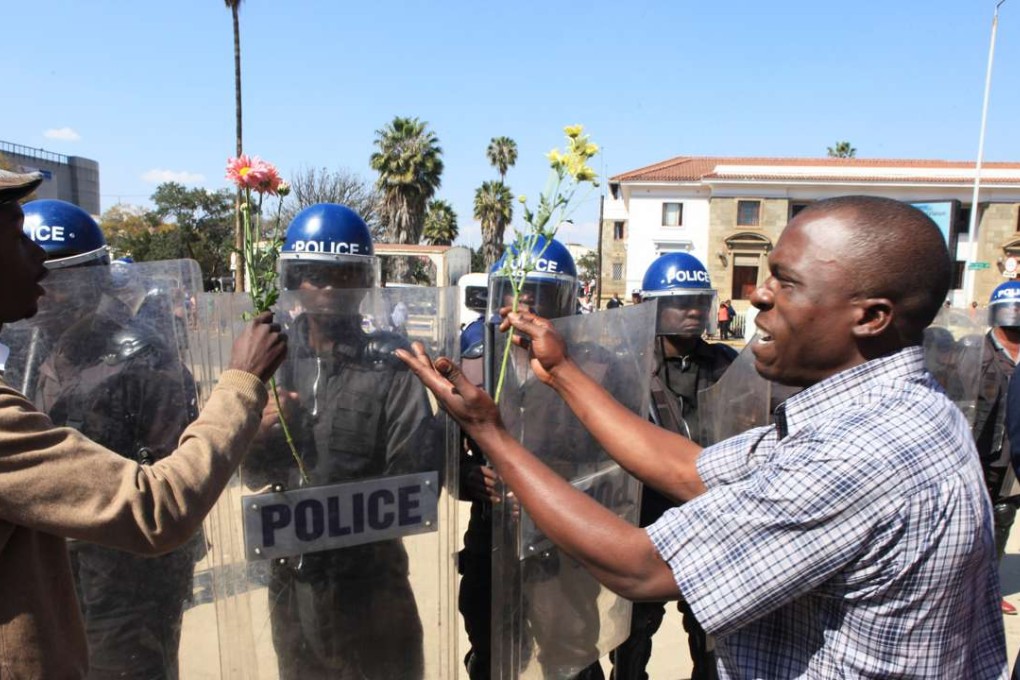Zimbabwe riot police use teargas, water cannon to break up anti ...