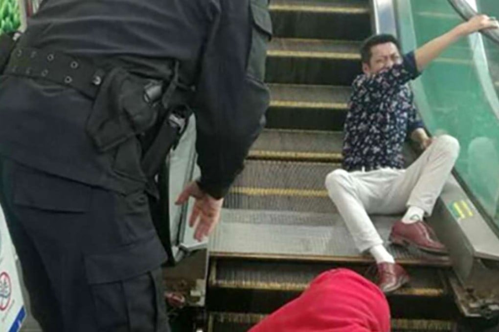man falls down escalator