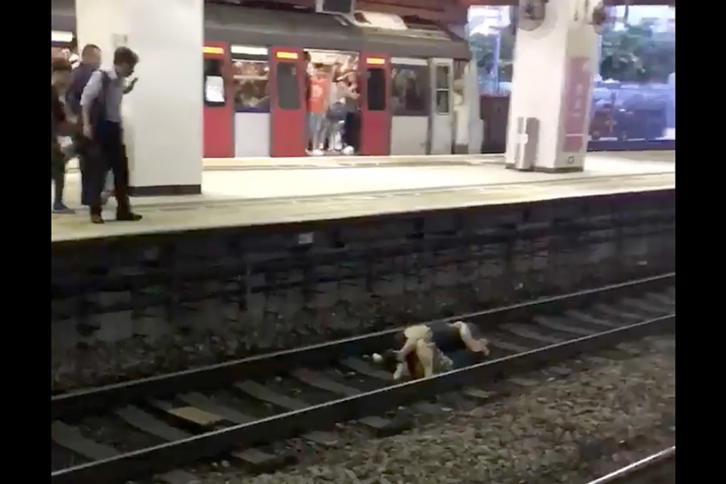 Two men get in a fight at Hong Kong MTR station, fall on track | South ...