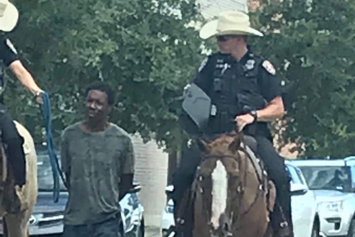 Photo of two white Texas police on horseback leading black man Donald ...