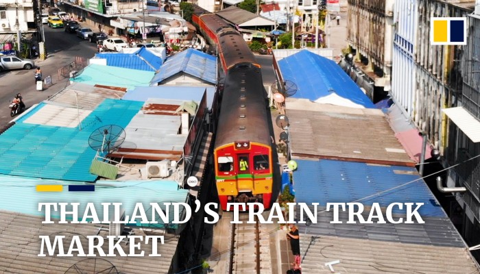 Tourists risk their lives to take selfies in Thai market built on train ...