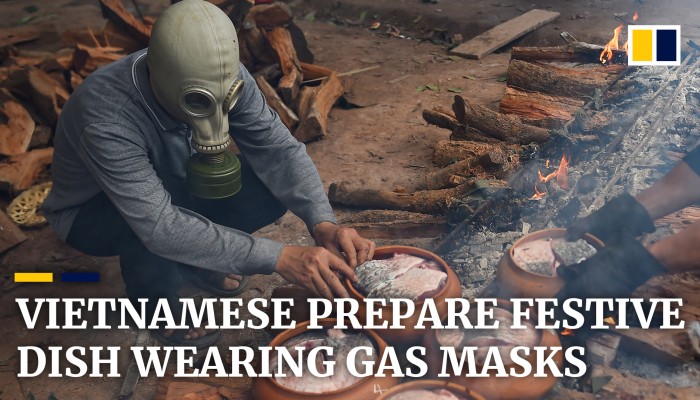 Vietamese prepare claypot carp for Lunar New Year while wearing gas ...