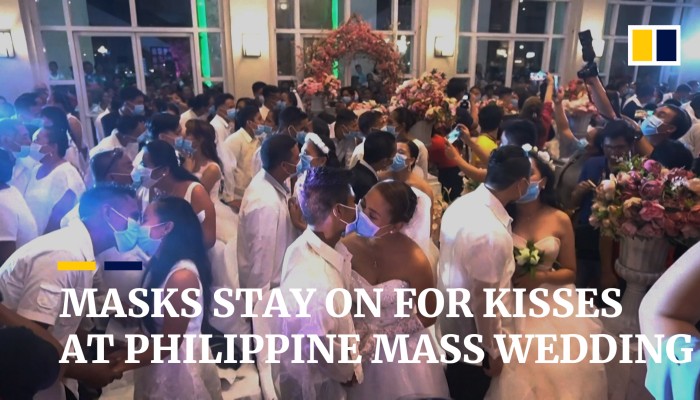 Kissing through masks, couples go ahead with annual mass wedding in the ...