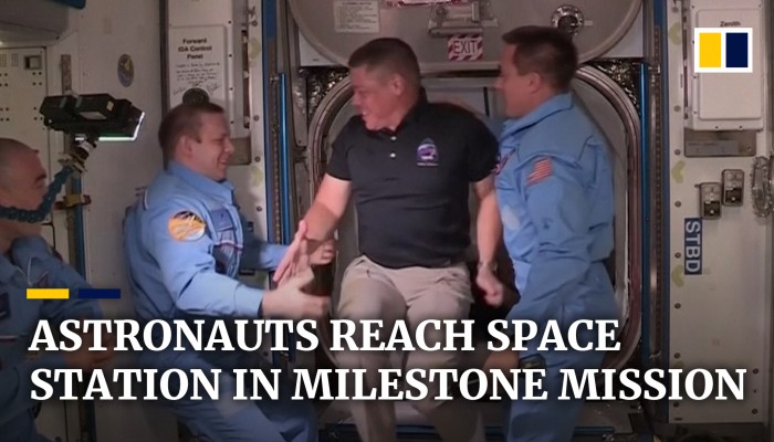 Astronauts arrive at International Space Station on historic mission ...