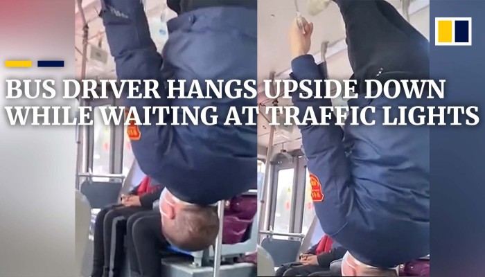 Bus driver in China hangs upside down while waiting at traffic lights ...