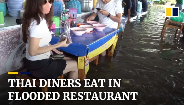Diners in Thailand enjoy meal in flooded restaurant amid heavy rain ...