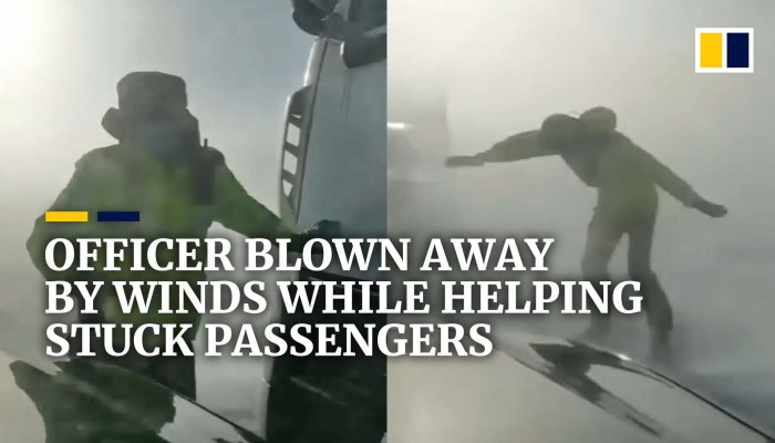 Police officer blown away by strong winds while helping stranded ...