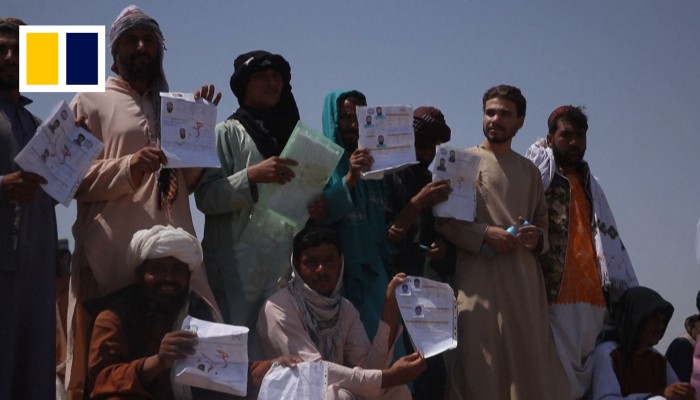 Taliban authorities shoot bullets into the air to disperse passport ...