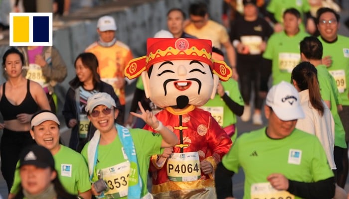 ‘It’s a big challenge’: Tens of thousands of runners battle cold front ...