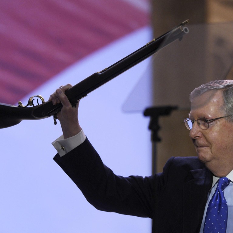 US Senate Republican leader Mitch McConnell takes stage with rifle ...