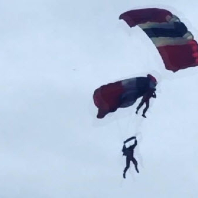 Moment Red Devil paratrooper was caught mid-air by team member when his ...
