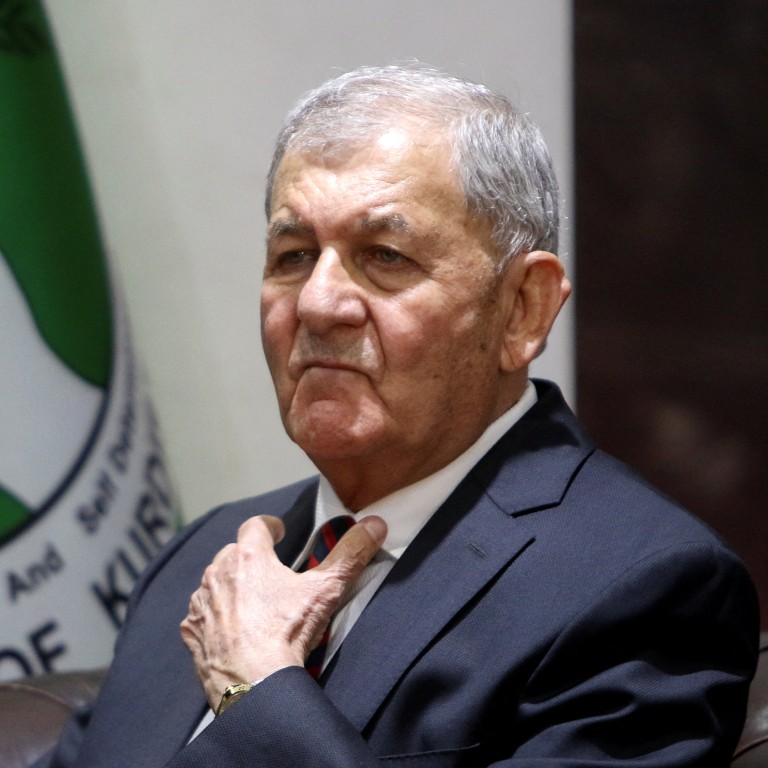 Braving rockets, Iraq MPs elect president who names PM after year of ...