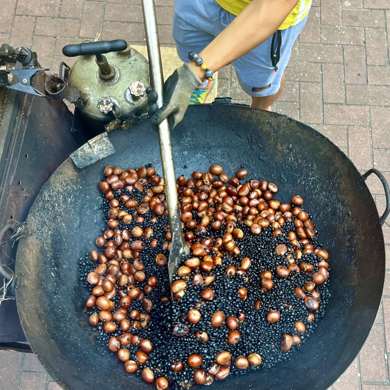 Chestnuts roasting in an open wok: Hong Kong hawker on a winter street ...