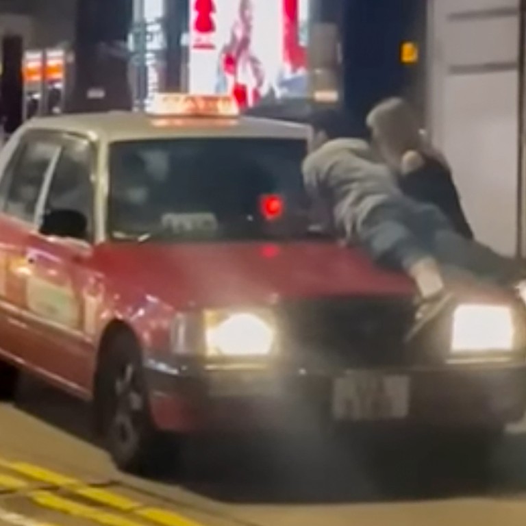 Hong Kong road rage video showing man clinging to reversing taxi goes ...