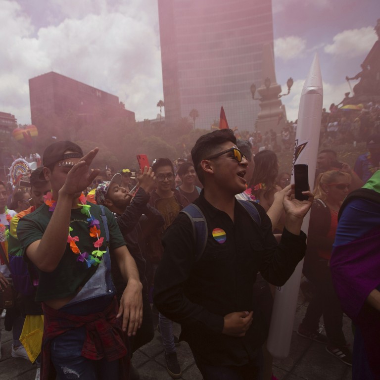 Rainbow flags lines the streets as tens of thousands join gay pride ...