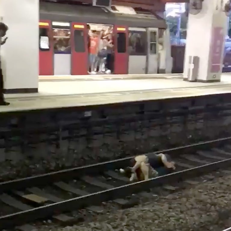 Two men get in a fight at Hong Kong MTR station, fall on track | South ...