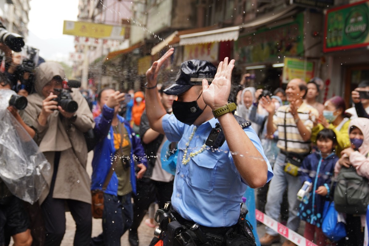 2 men arested after allegedly soaking Hong Kong police officers with ...
