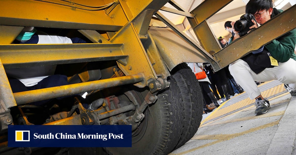 Illegal workers being smuggled into Hong Kong hidden under trucks ...