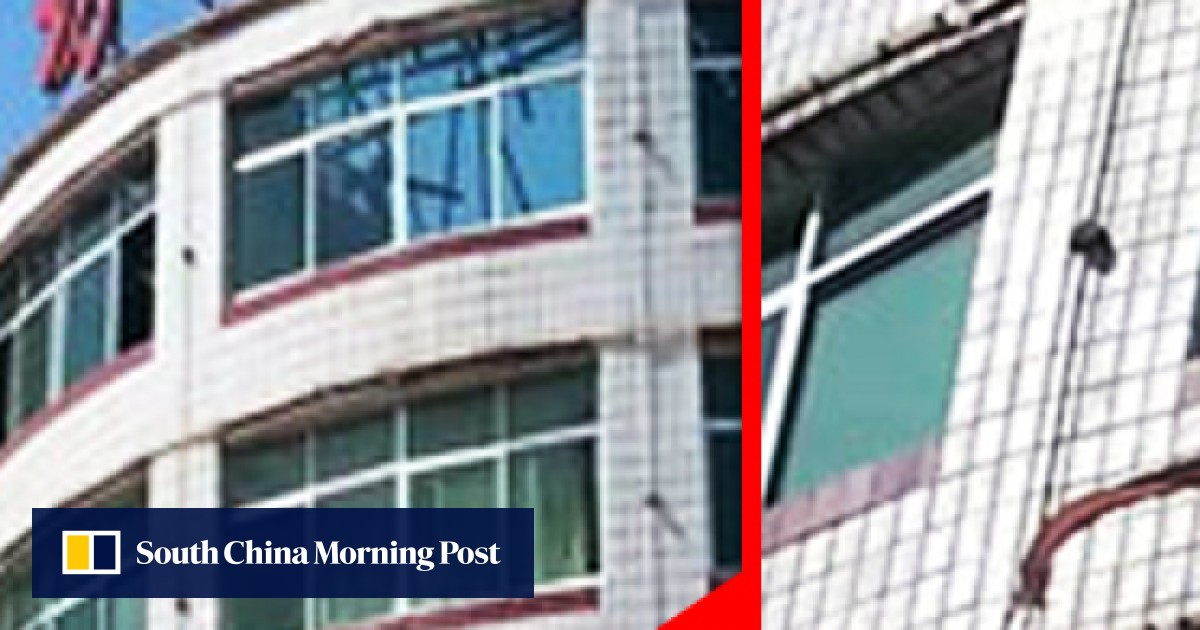 Tattered Chinese national flag flying outside government building ...
