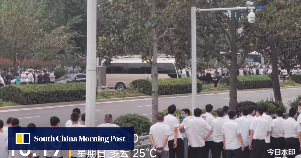White-shirted group attacks protesters at China banking scandal ...
