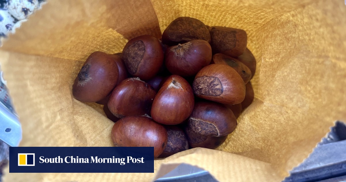 Chestnuts roasting in an open wok: Hong Kong hawker on a winter street ...