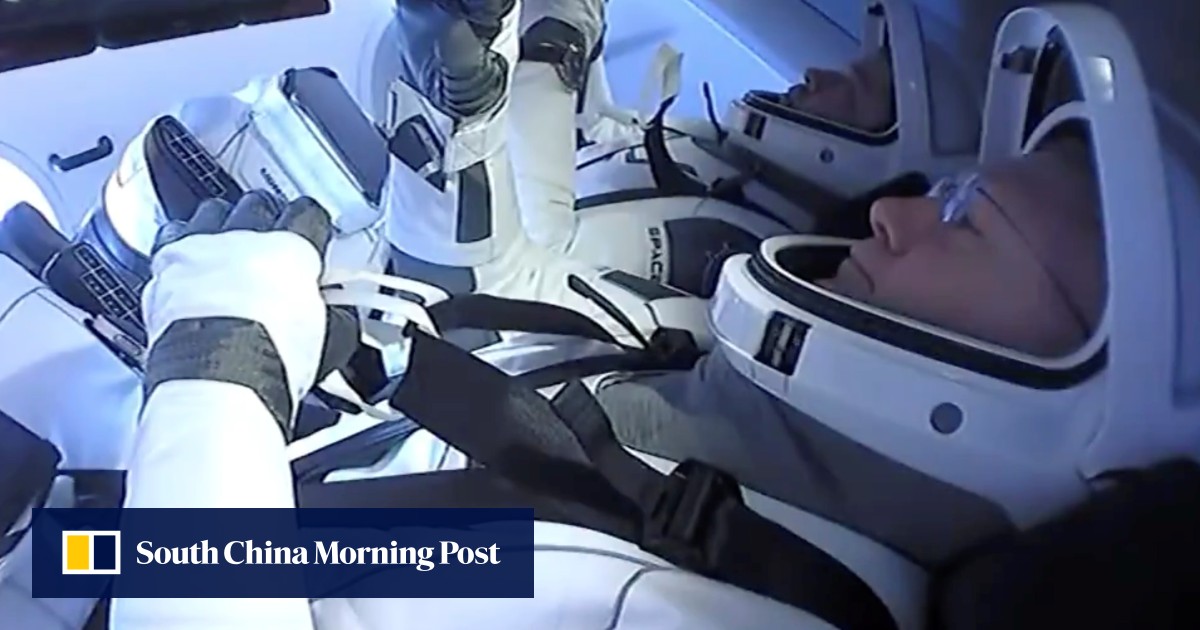 Nasa astronauts make historic splashdown after return to Earth on ...