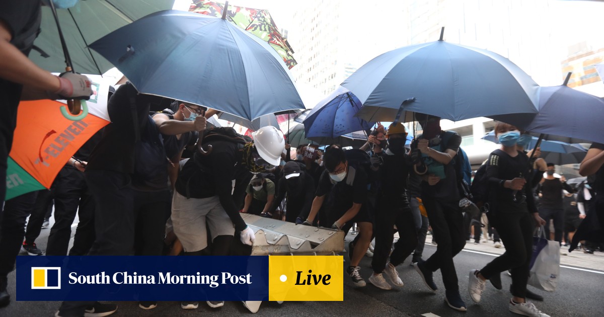 Defying police orders, Hong Kong extradition bill protesters block ...